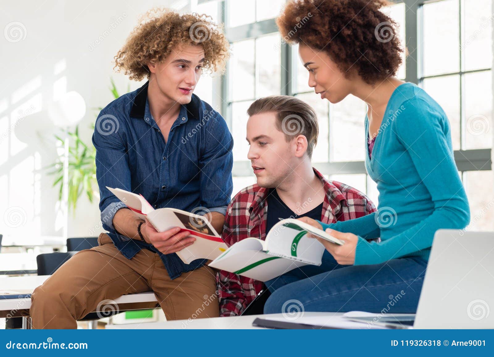 Three Students Comparing Information from Two Different Textbooks Stock ...