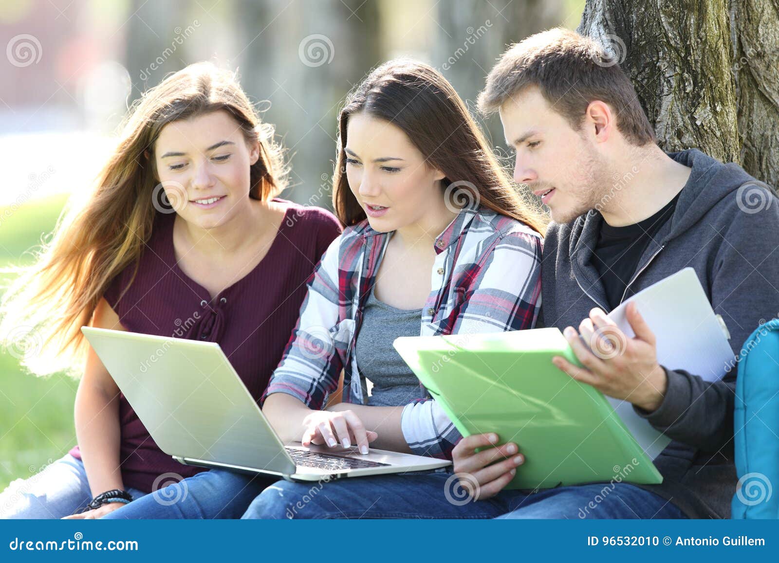 Three Students Learning Online in a Park Stock Photo - Image of lesson ...