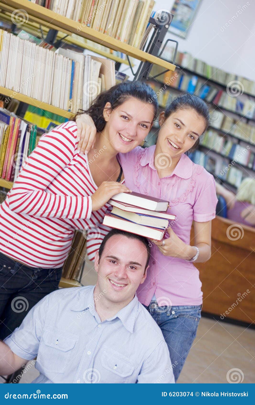 Three students in library stock photo. Image of lifestyle - 6203074