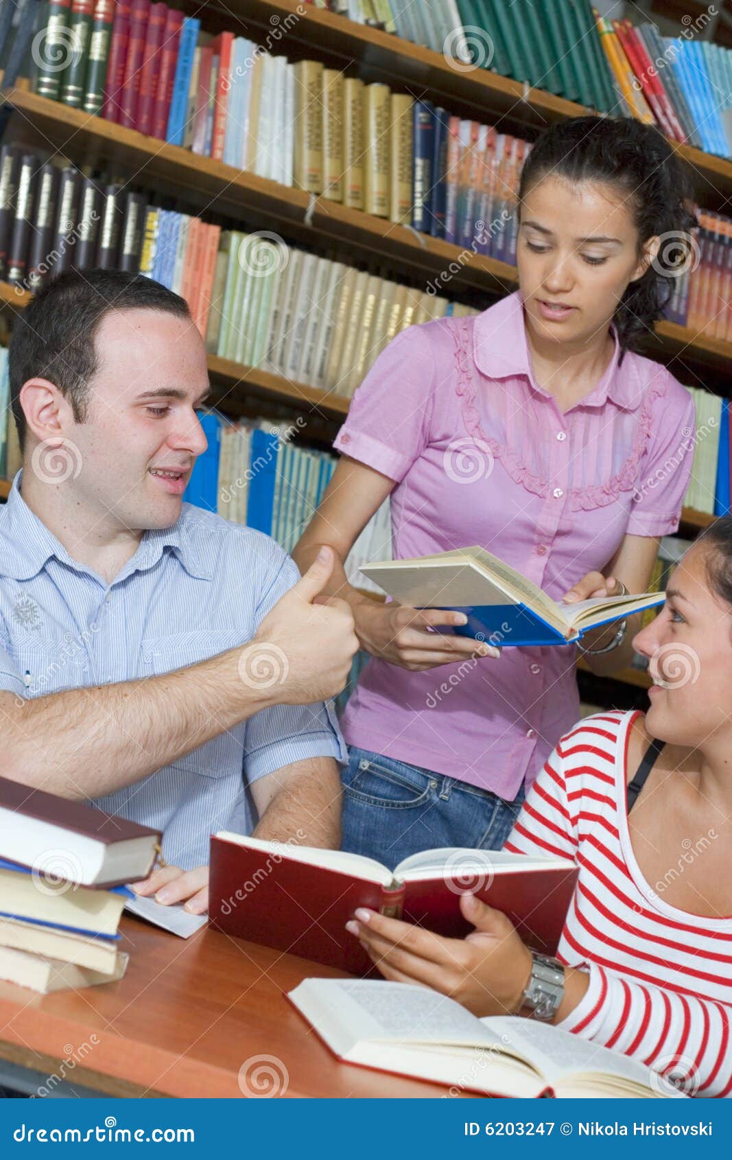 Three students in library stock image. Image of male, female - 6203247