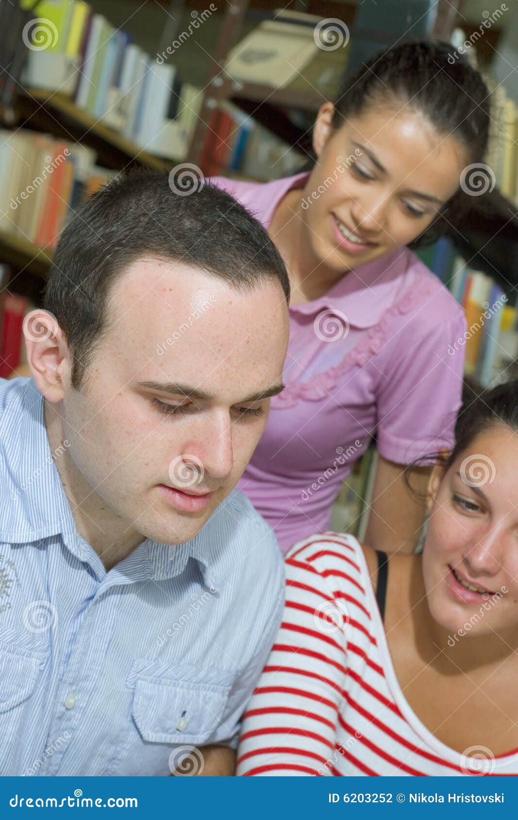 Three students in library stock photo. Image of student - 6203252
