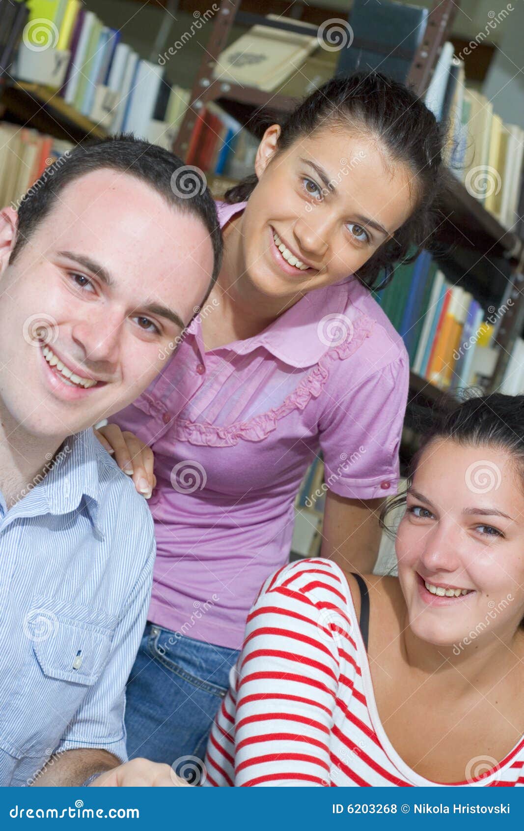 Three students in library stock photo. Image of person - 6203268