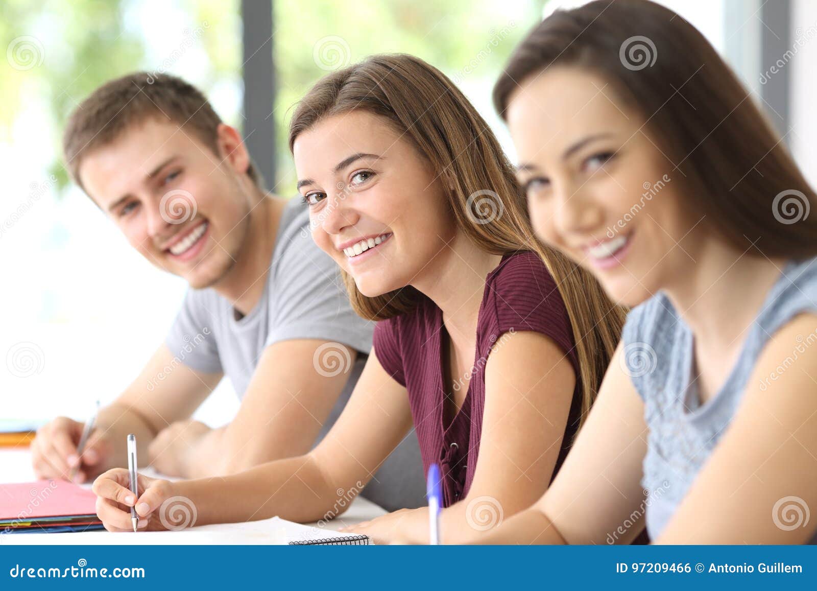 Three Students Looking at You at Classroom Stock Photo - Image of ...