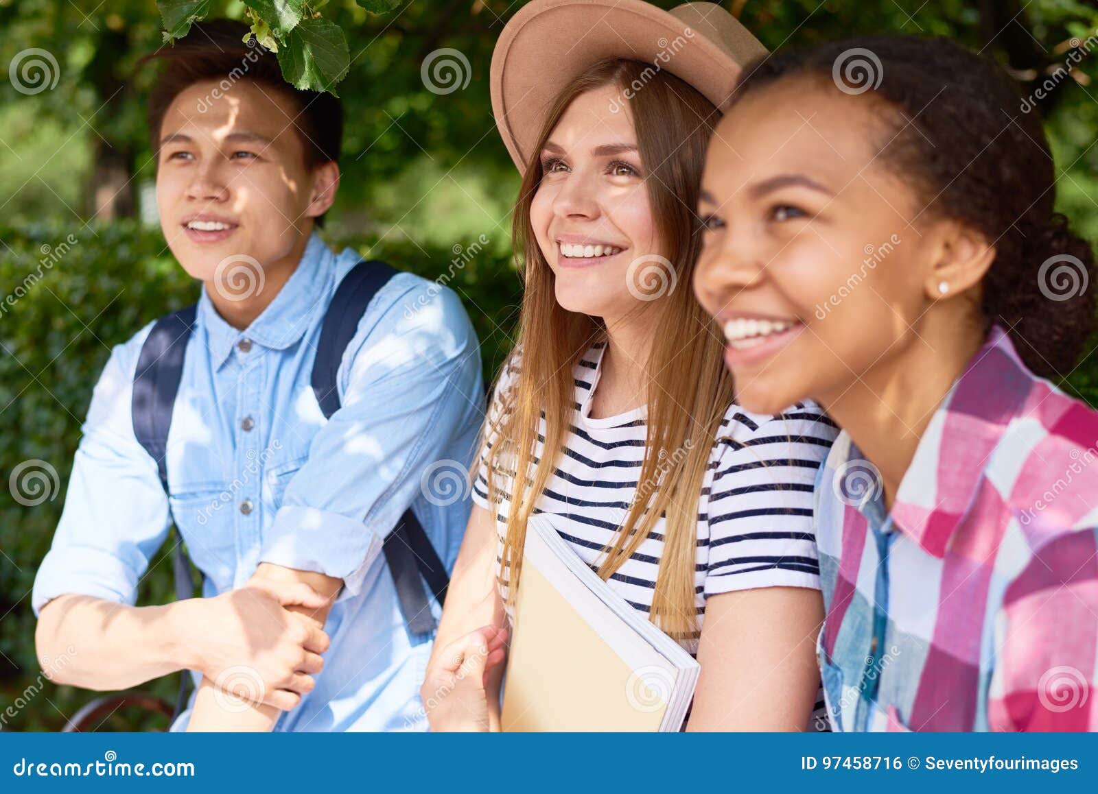 Three Students in Park stock photo. Image of sunlight - 97458716