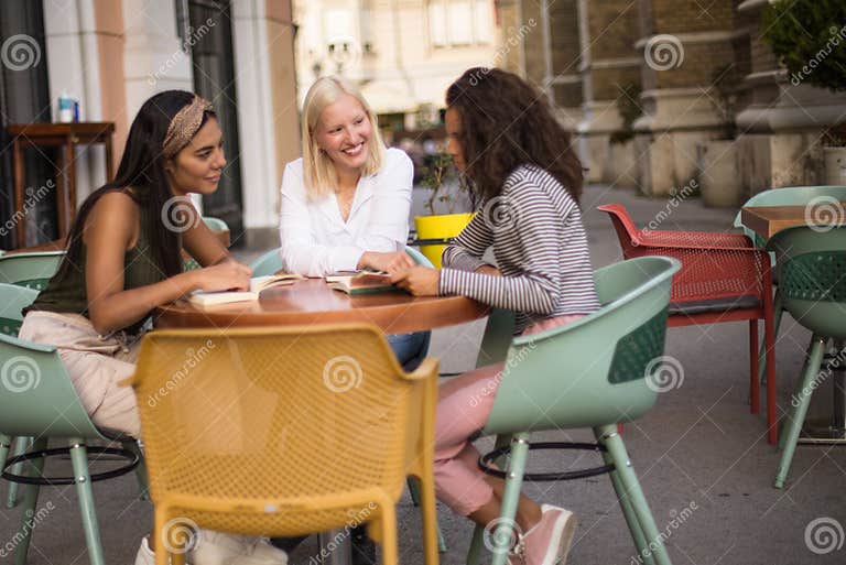 Three Students Reading Book in CafÃ© Reading Time Stock Image - Image ...