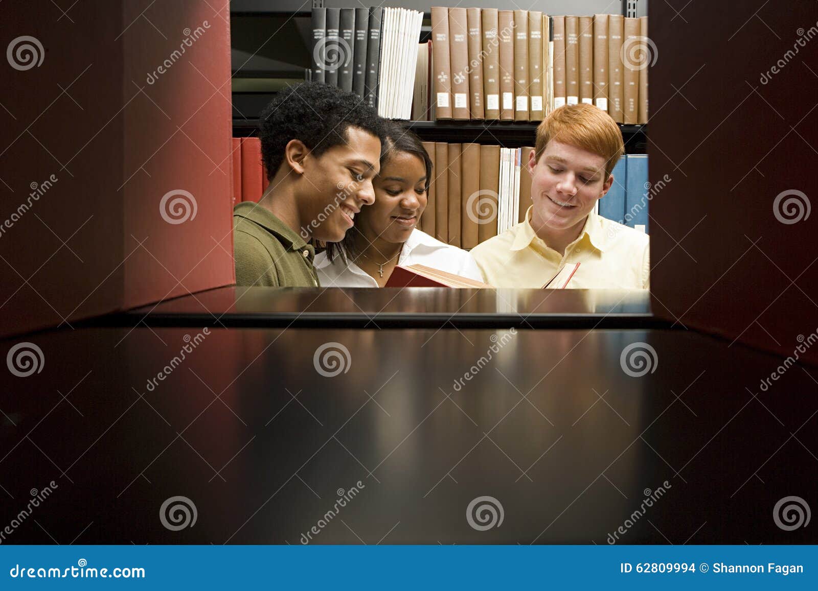 Three Students Reading in the Library Stock Photo - Image of education ...