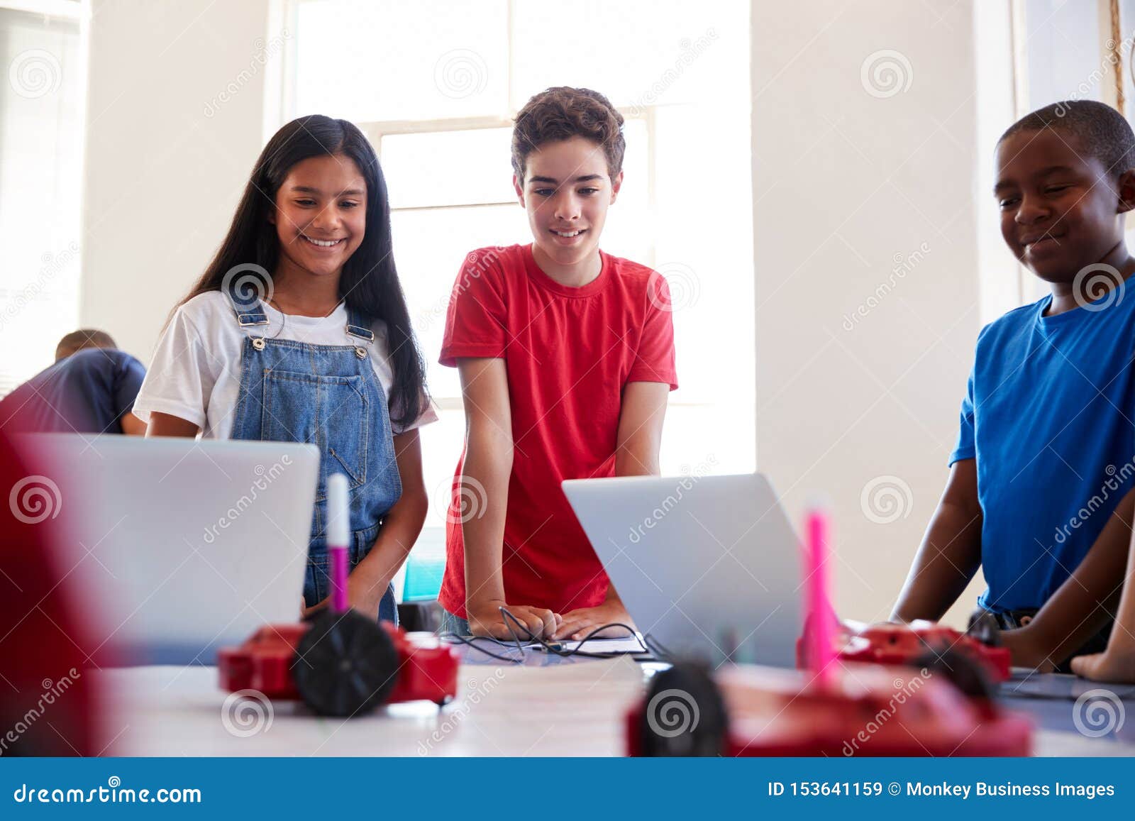 Three Students in after School Computer Coding Class Learning To ...