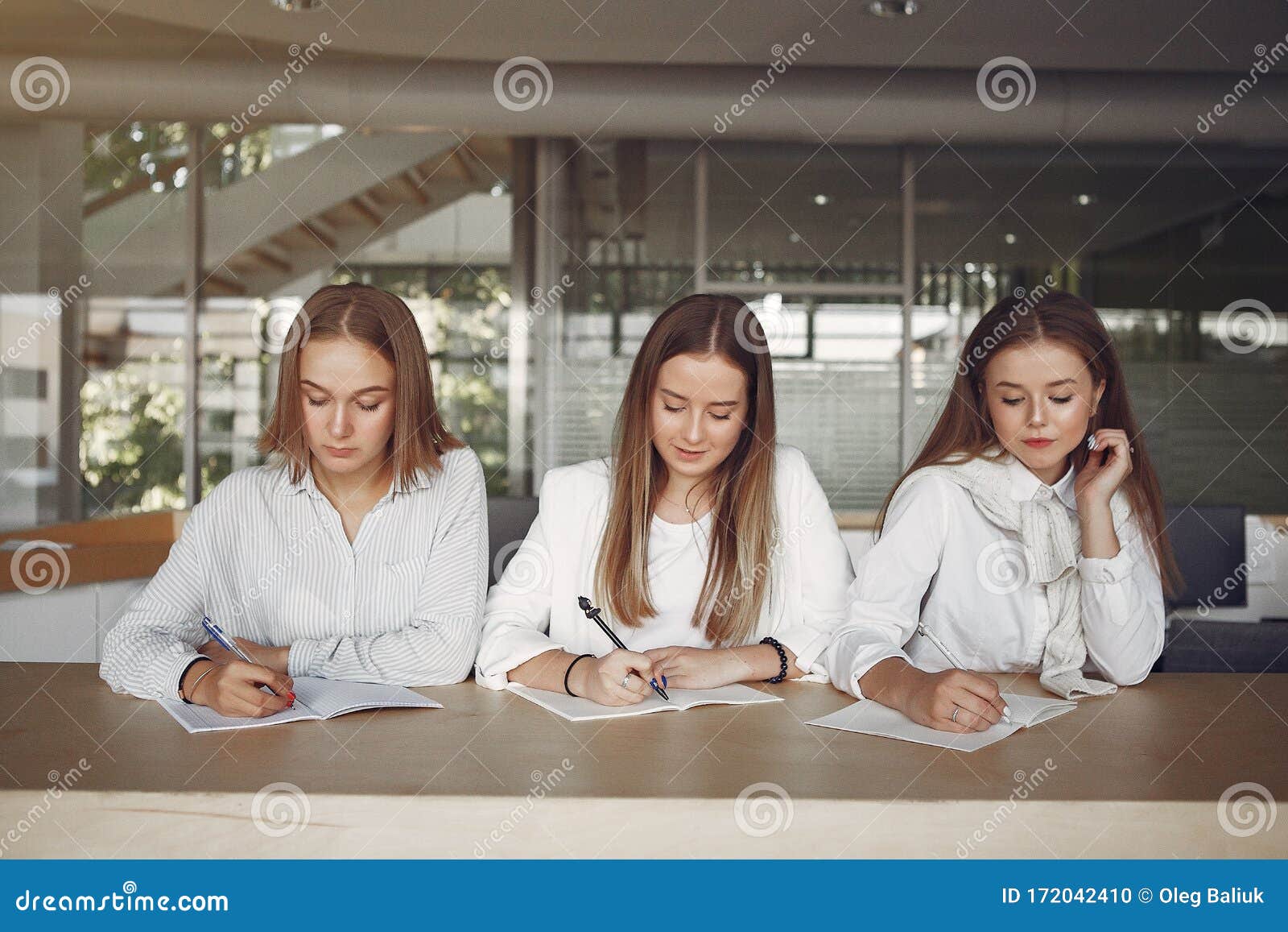 Three Students Sitting at the Table in a Class Stock Photo - Image of ...