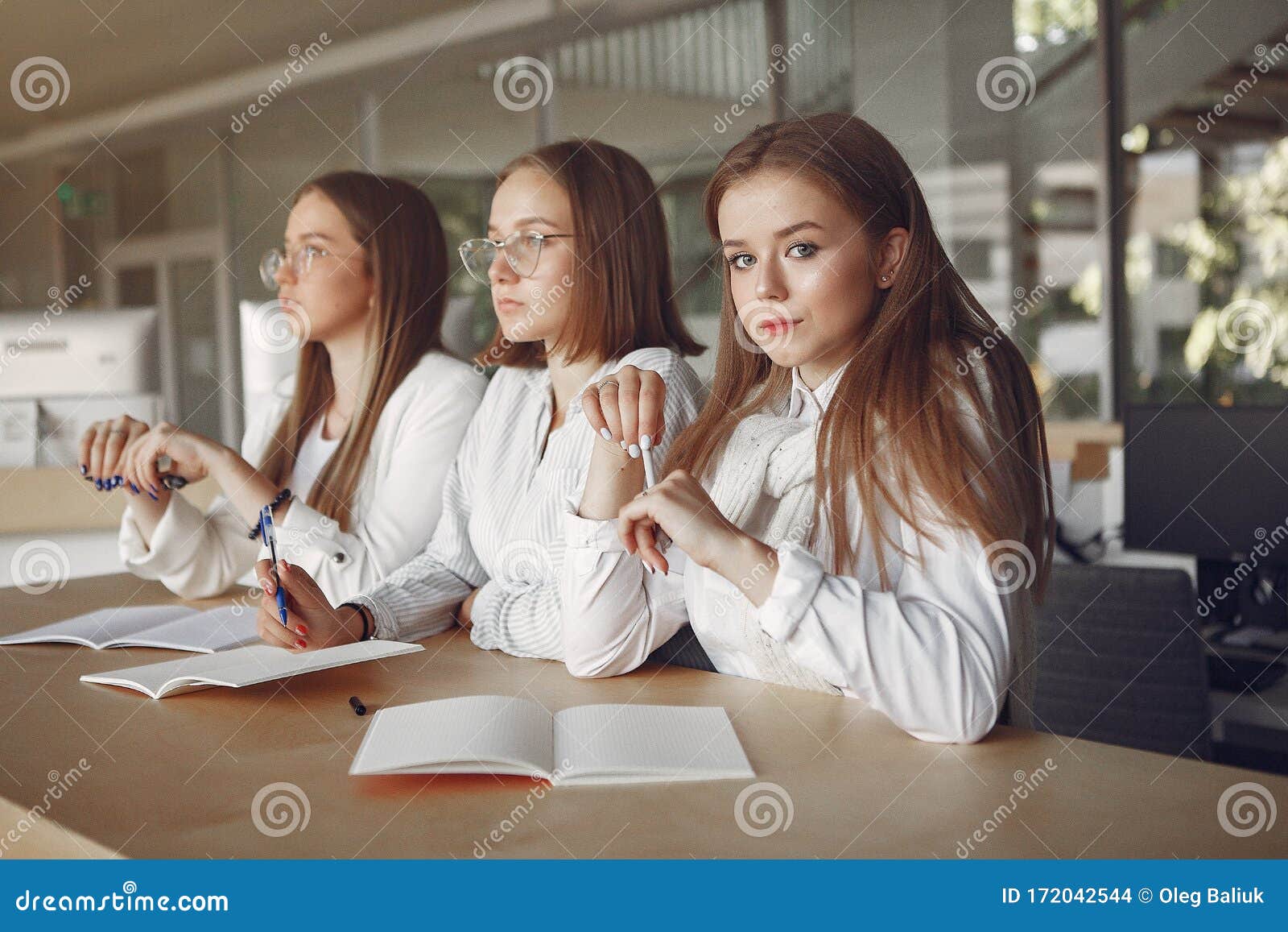 Three Students Sitting at the Table in a Class Stock Photo - Image of ...