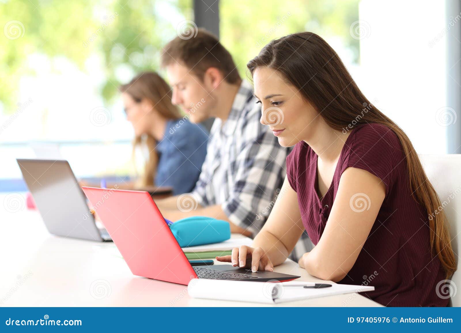 Three Students Studying on Line in a Classroom Stock Photo - Image of ...