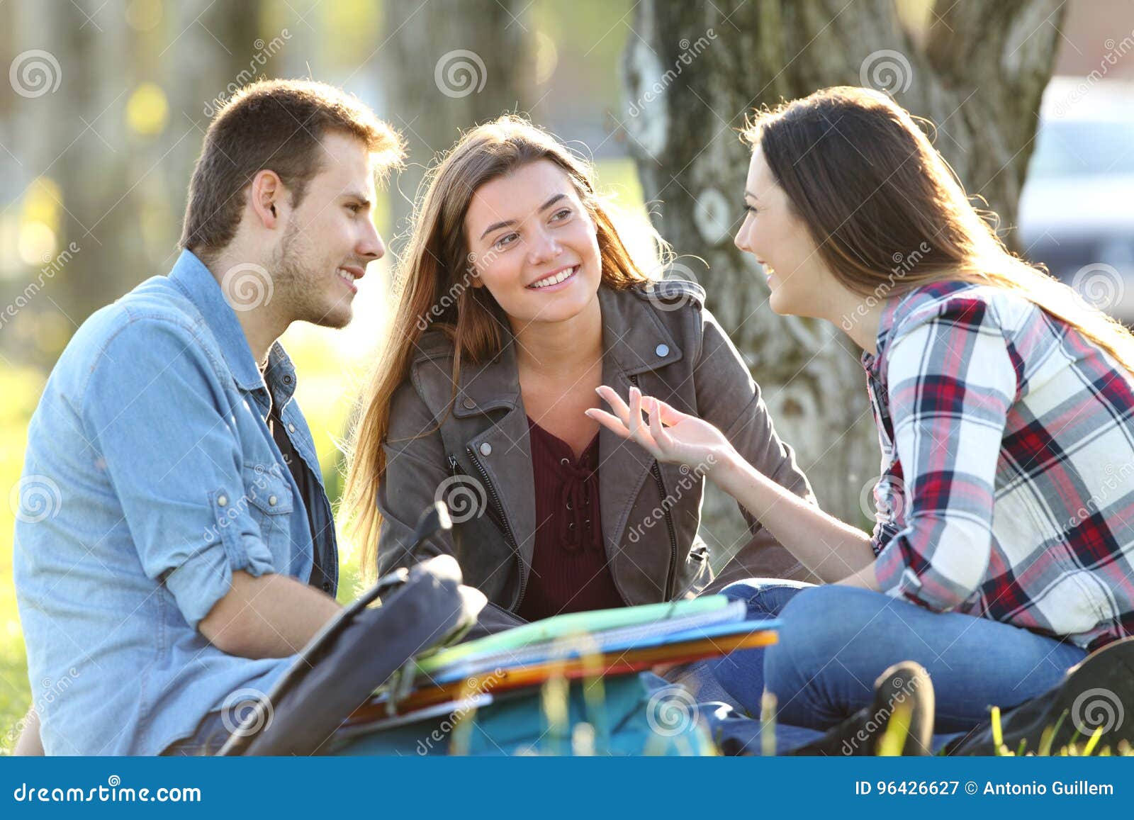 Three Students Talking after Class Stock Image - Image of campus ...