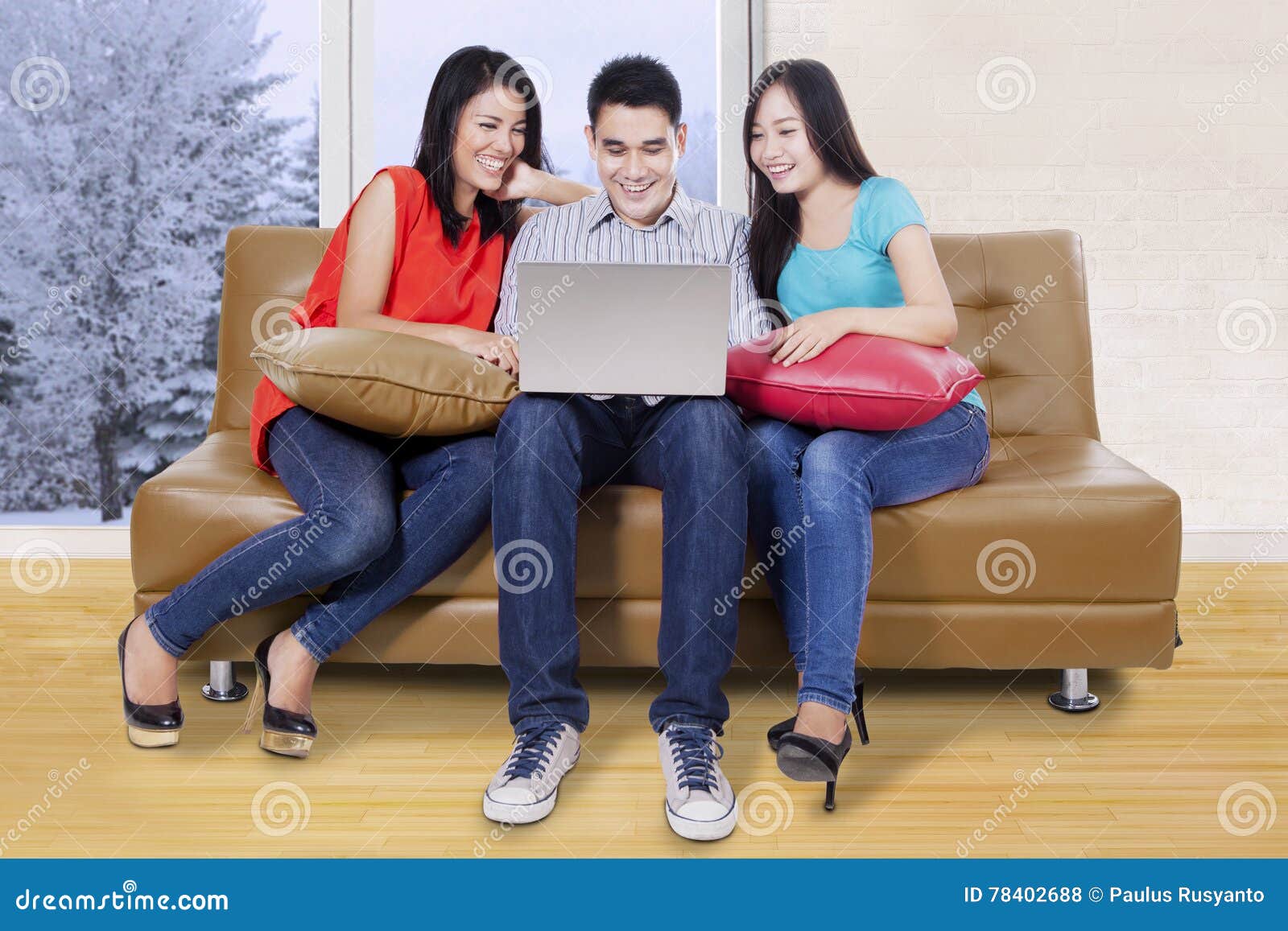 Three Students Using Laptop in the Couch Stock Photo - Image of couch ...