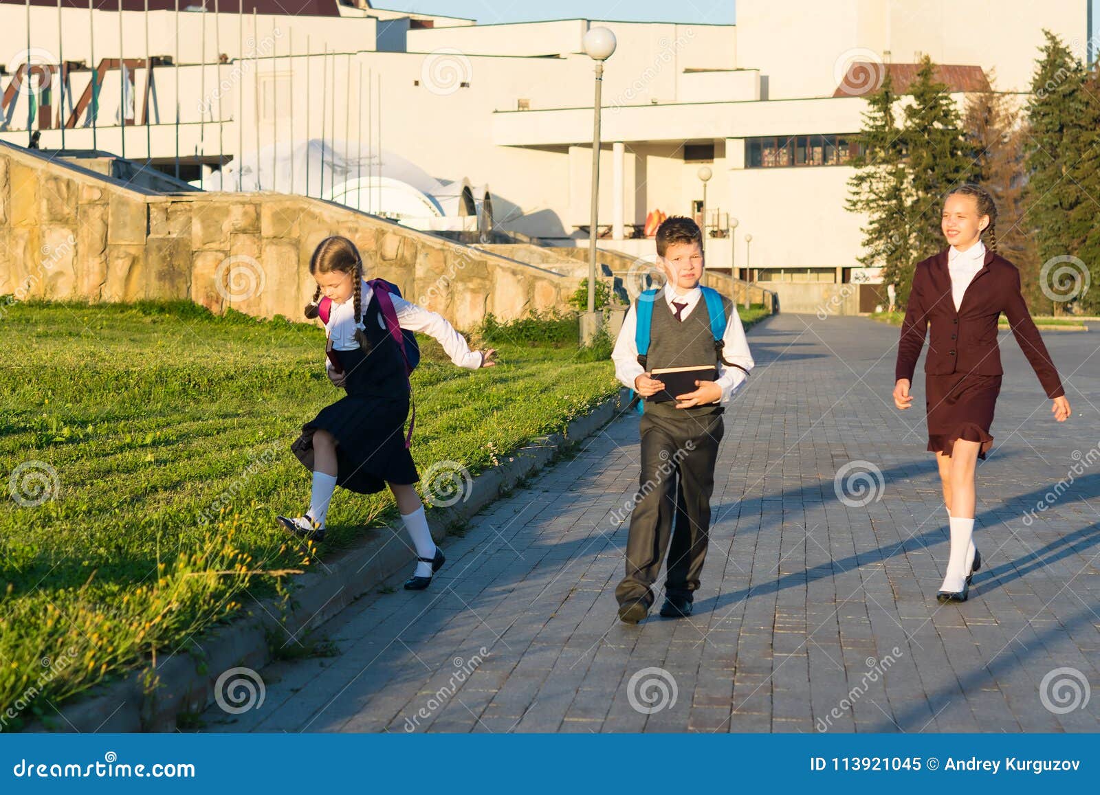 Three Students Walk in the Park with Portfolios after Classes Stock ...