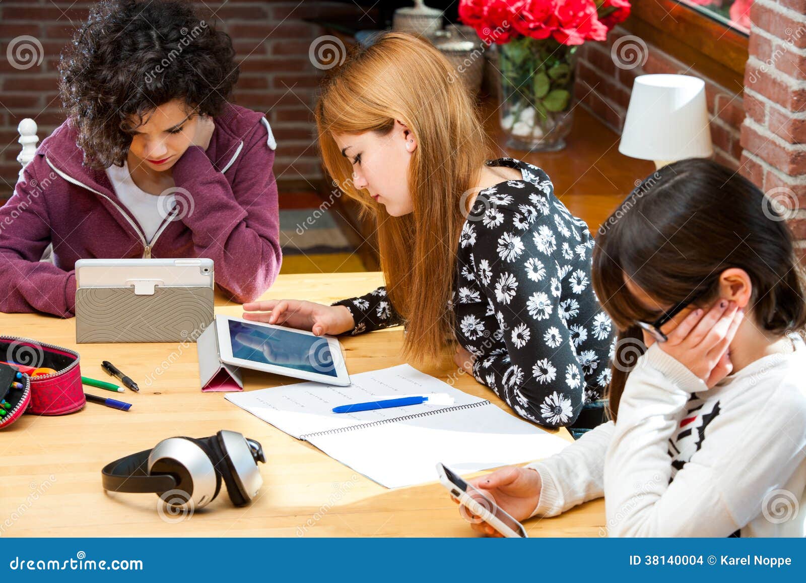 Three Students Working on Digital Devices. Stock Photo - Image of desk ...