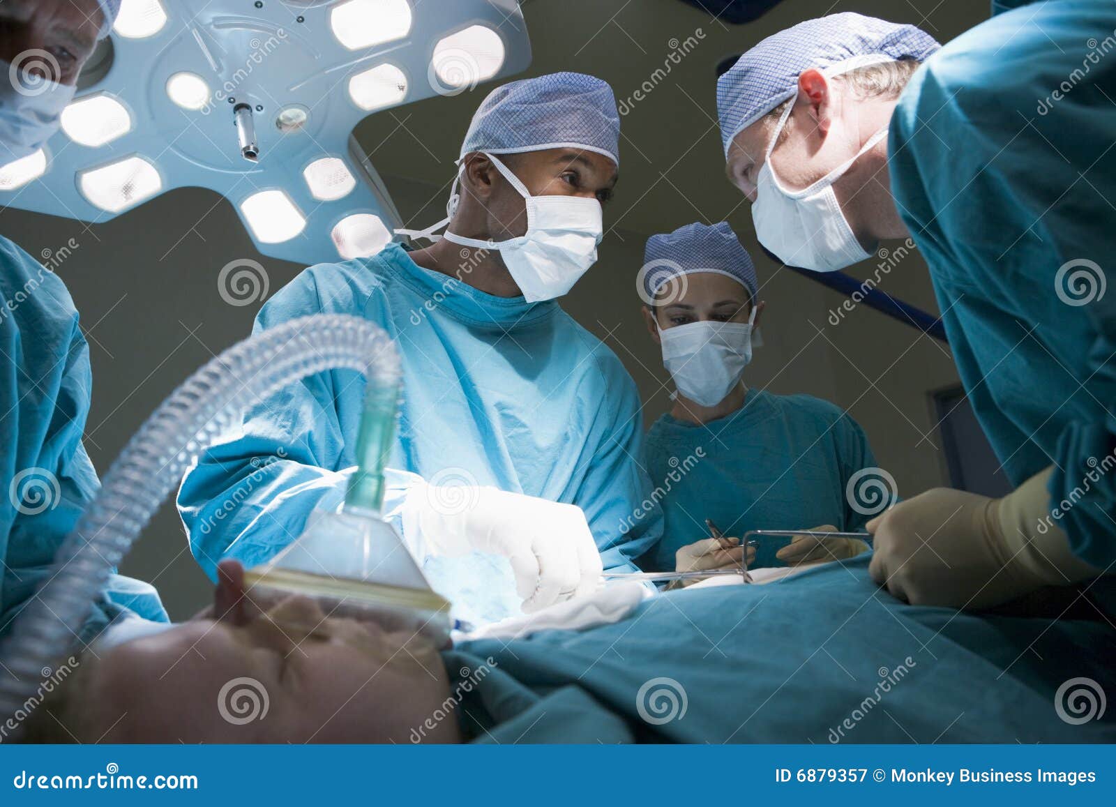 Three Surgeons Operating on a Patient Stock Image - Image of mask ...