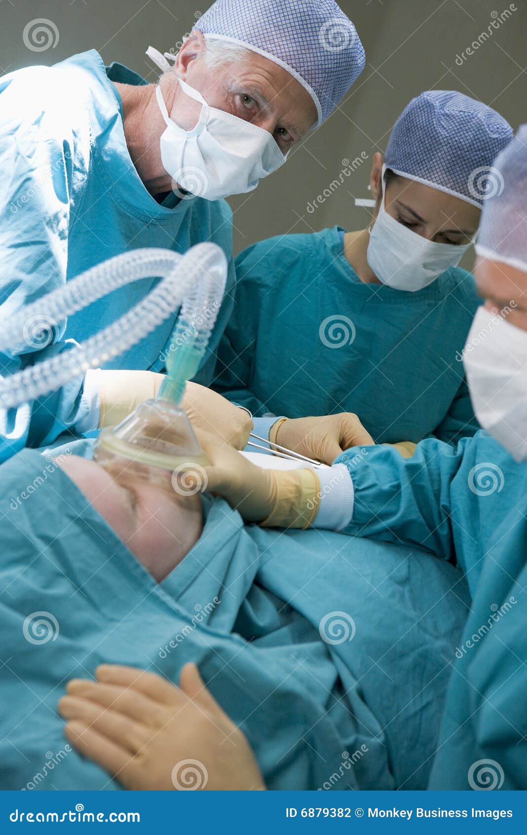 Three Surgeons Operating on a Patient Stock Photo - Image of indoors ...