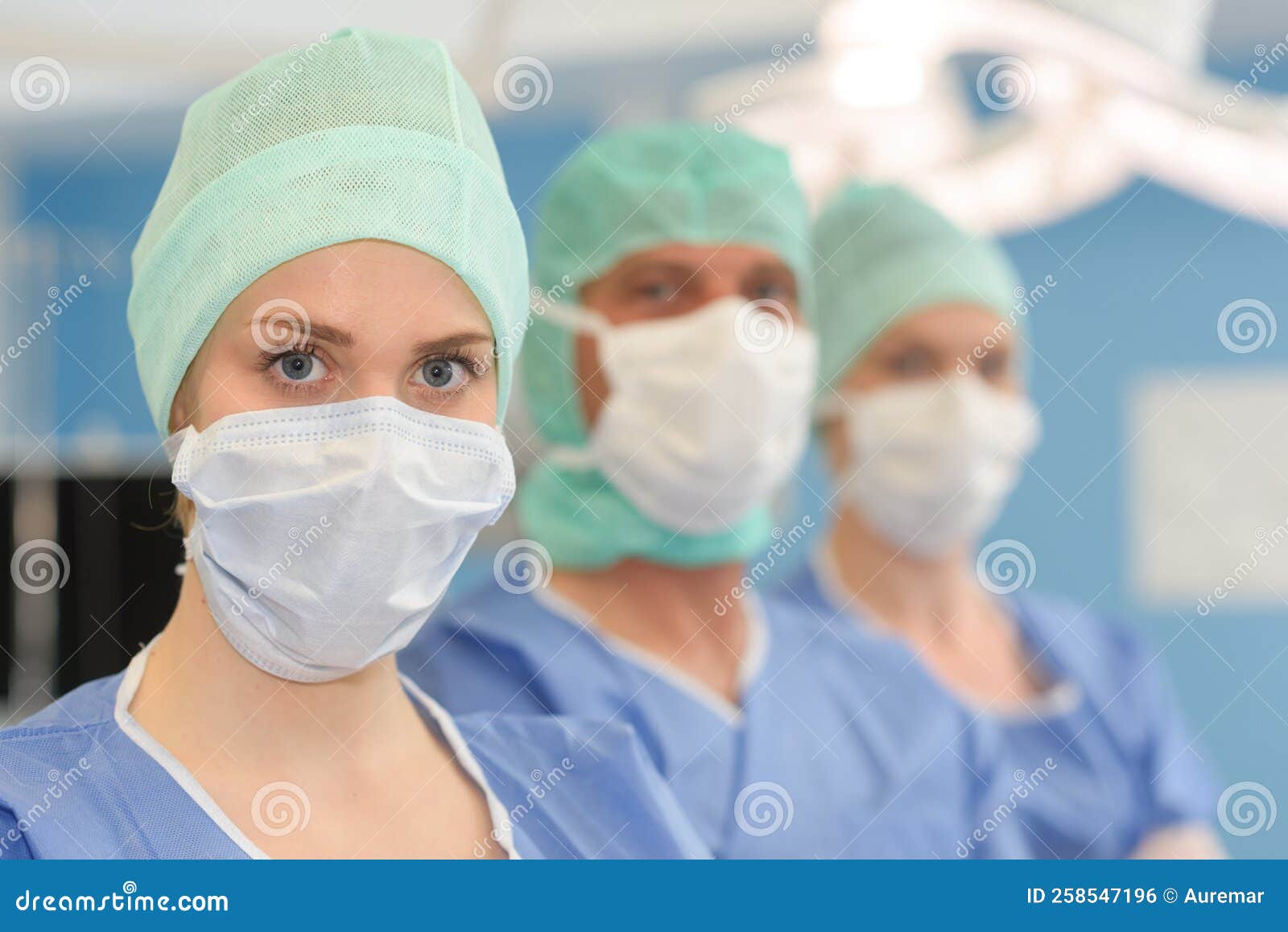 Three Surgeons at Work Operating in Surgical Theatre Stock Photo ...