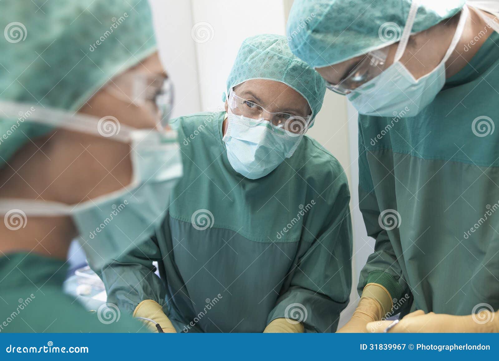 Three Surgeons at Work in Operating Theatre Stock Image - Image of ...