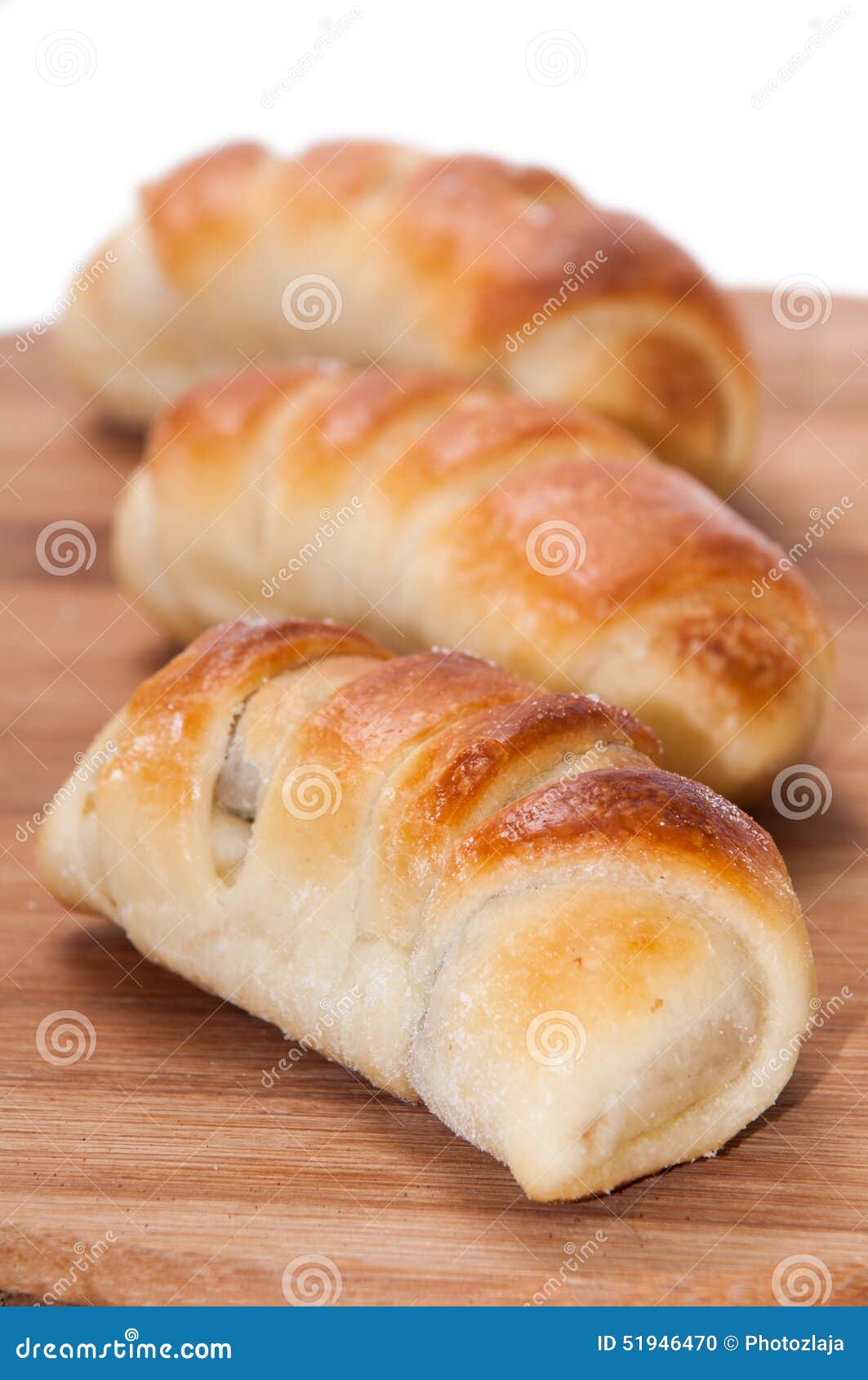 Three sweet rolls in a row stock photo. Image of hardwood - 51946470