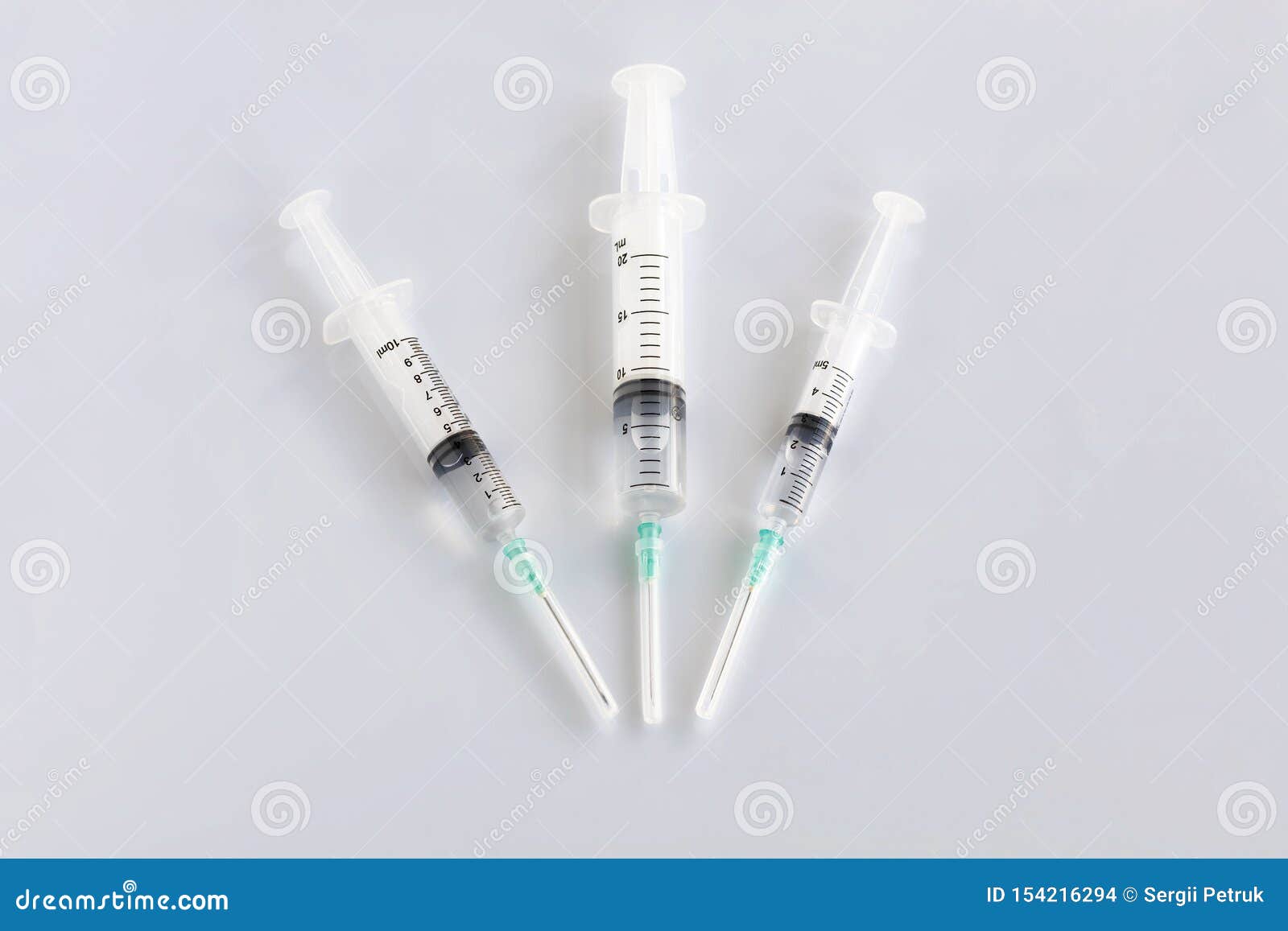 Several Different Syringes on a White Smooth Table are Filled with ...