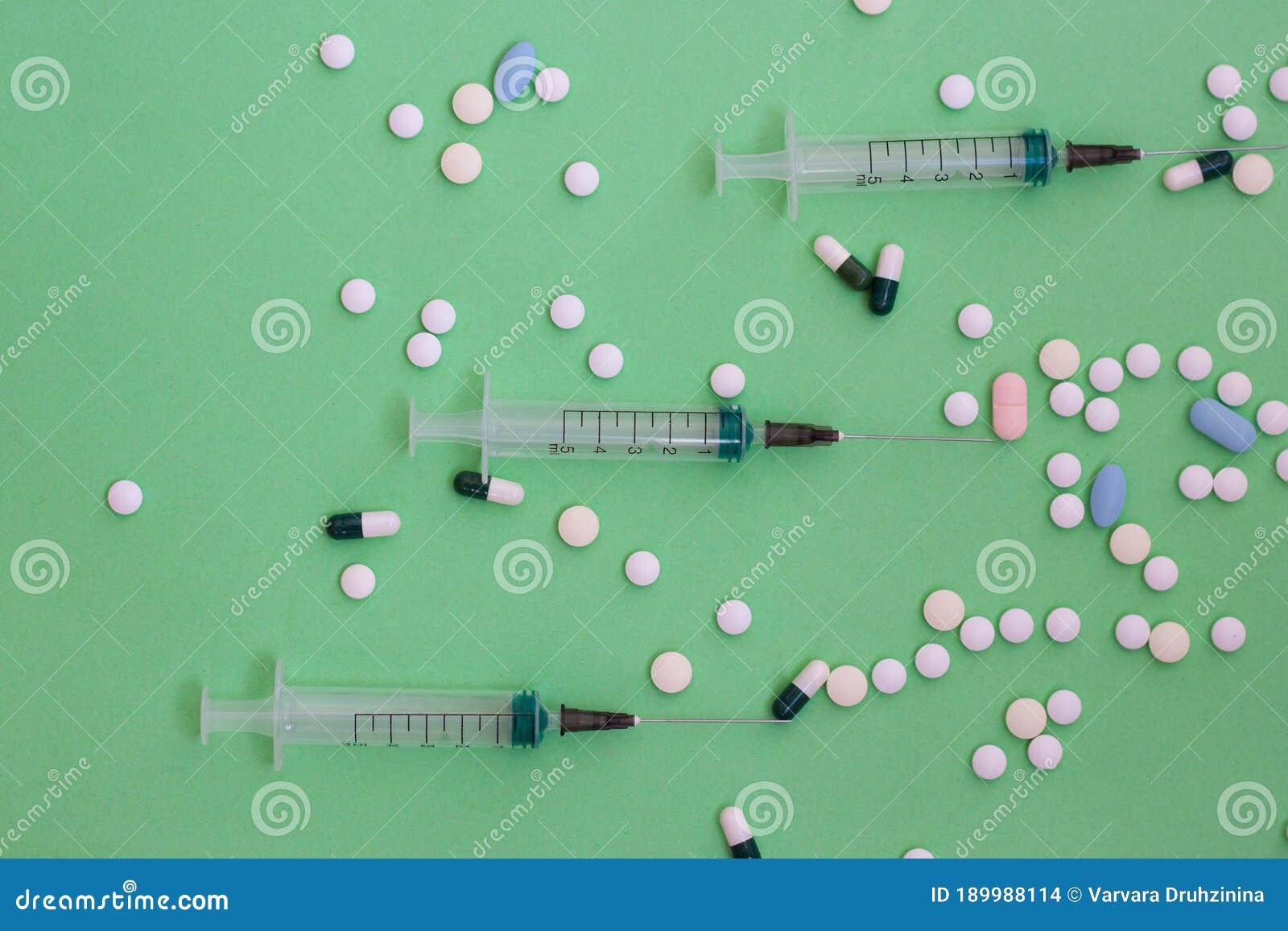 Three Syringes with a Needle Empty Lying on a Green Background and a ...