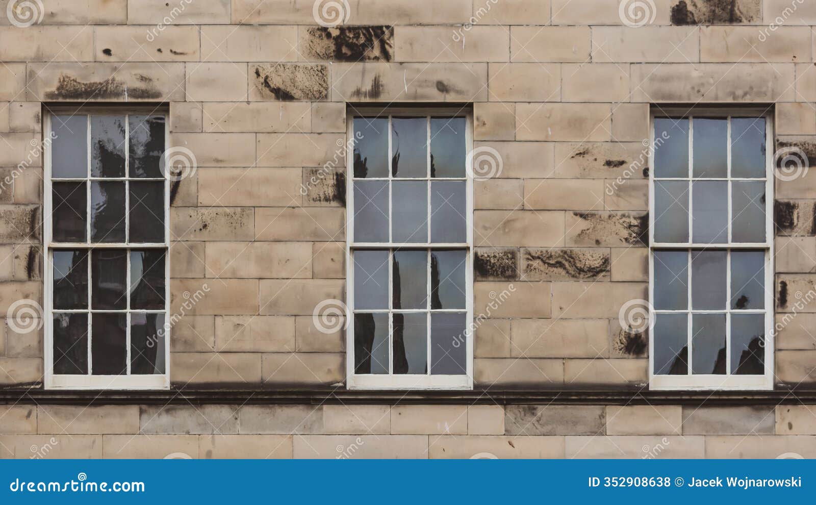 Three Tall, Rectangular Windows Set into a Weathered Stone Wall Stock ...