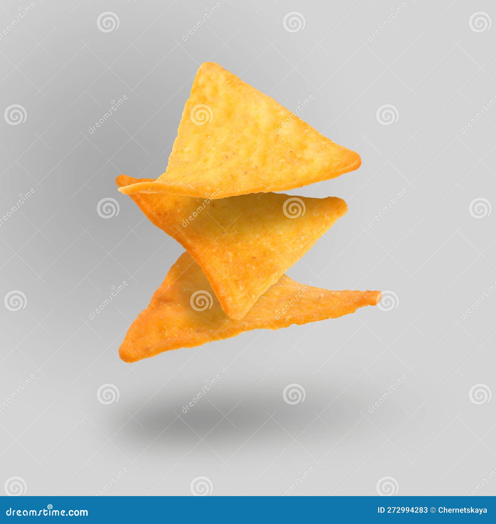 Three Tasty Tortilla Chips Falling on Grey Background Stock Image ...