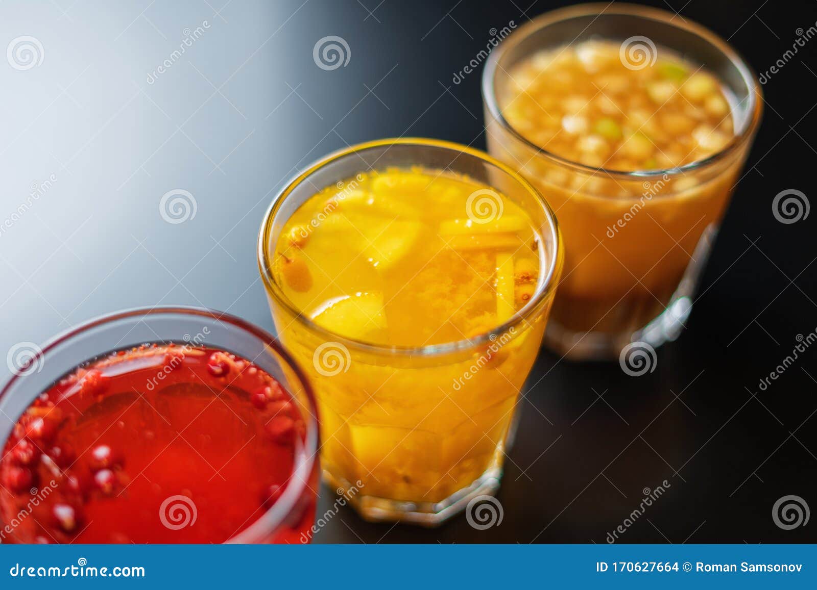 Three Teas from Different Berries and Fruits on a Black Table in a Cafe ...