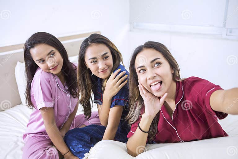 Three Teenage Girls Taking Selfie Photo In Bedroom Stock Image Image