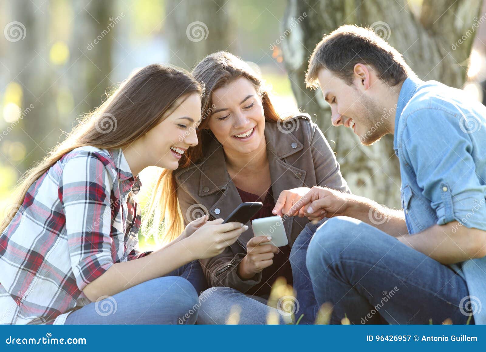 Three Teens Sharing on Line Content on Phones Stock Image - Image of ...