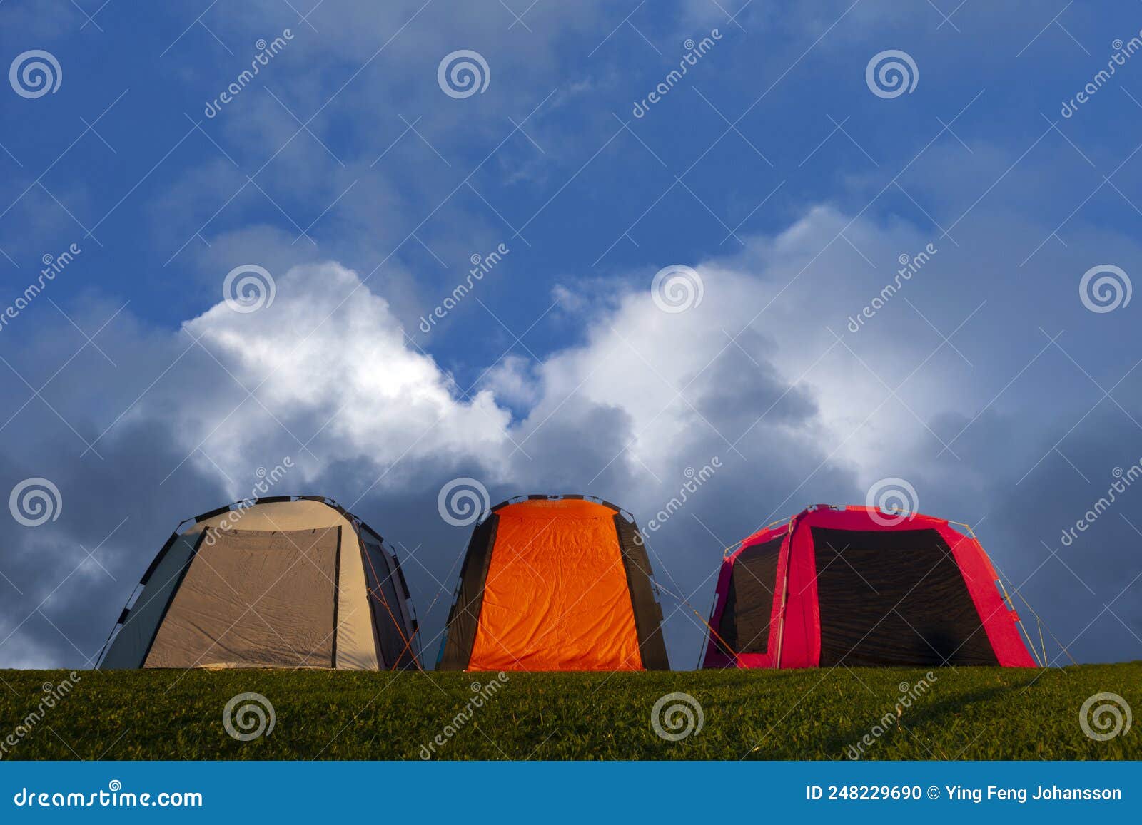 Three tents on blue sky stock photo. Image of grass - 248229690
