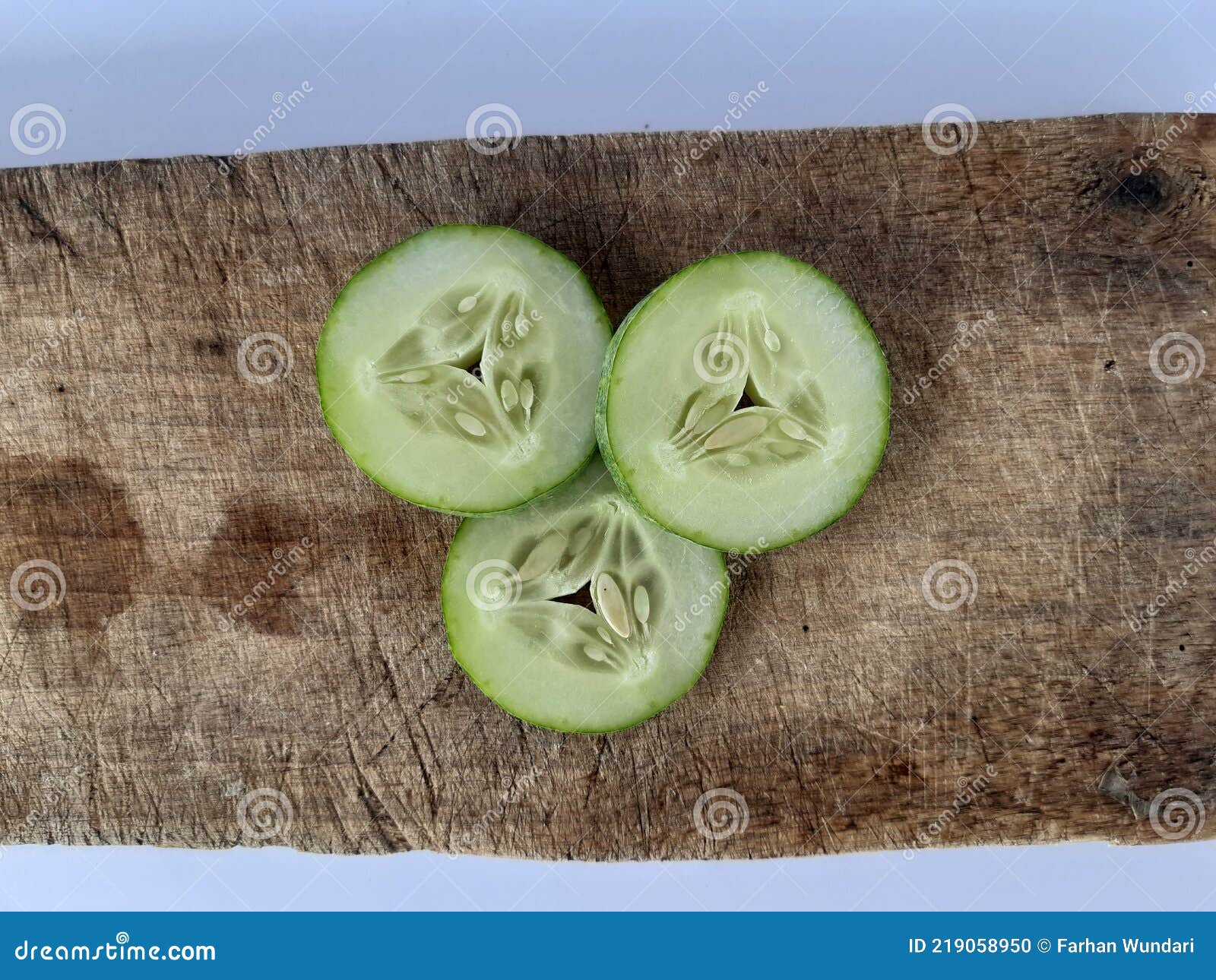Three Thin Cucumber Slices Arranged in a Triangular Pattern Against a ...