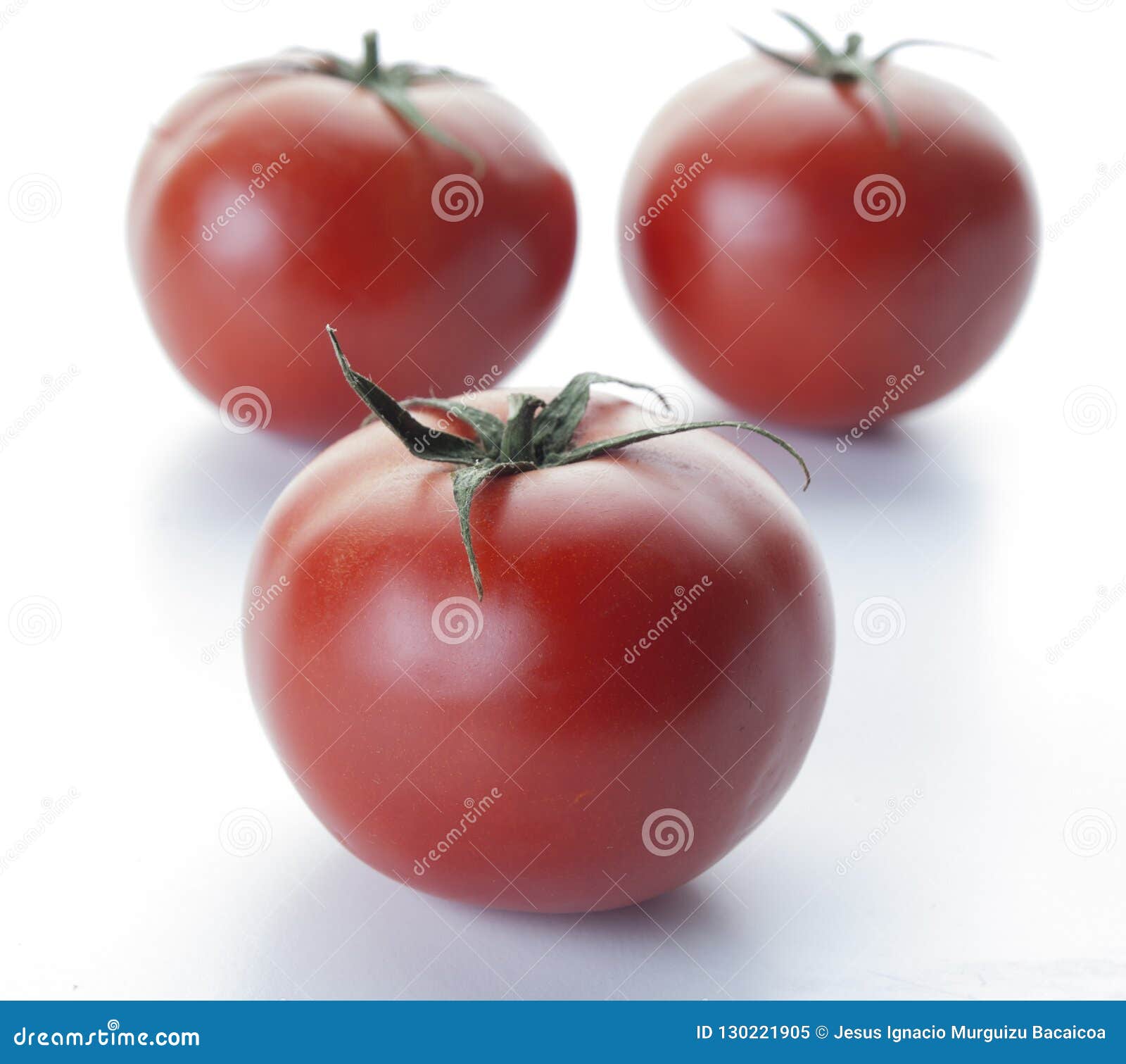 Three Tomatoes in the Foreground with Their Leaves Stock Image - Image ...