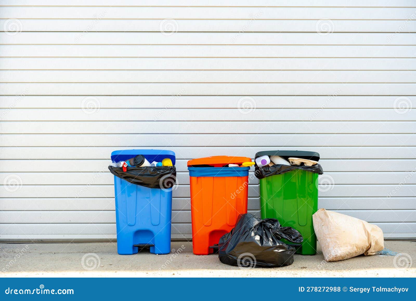 Three Trash Containers Full of Garbage Near the Building Stock Photo ...