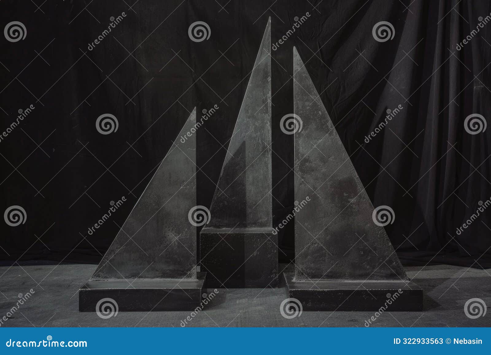 Three Triangular Steel Sculptures Stand on a Dark, Minimalist ...