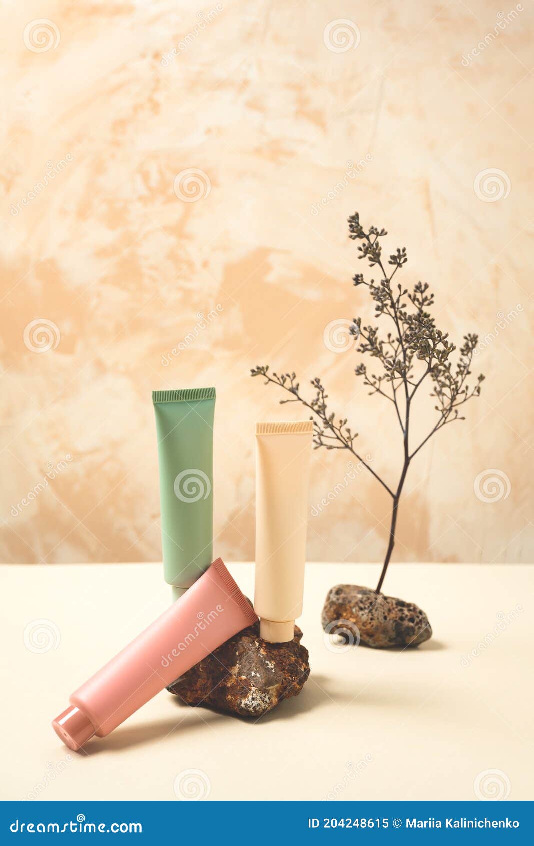 Three Tubes Of Hand Cream On Stone Podiums In Front Of Branch With Eucalyptus Fruit Cosmetic
