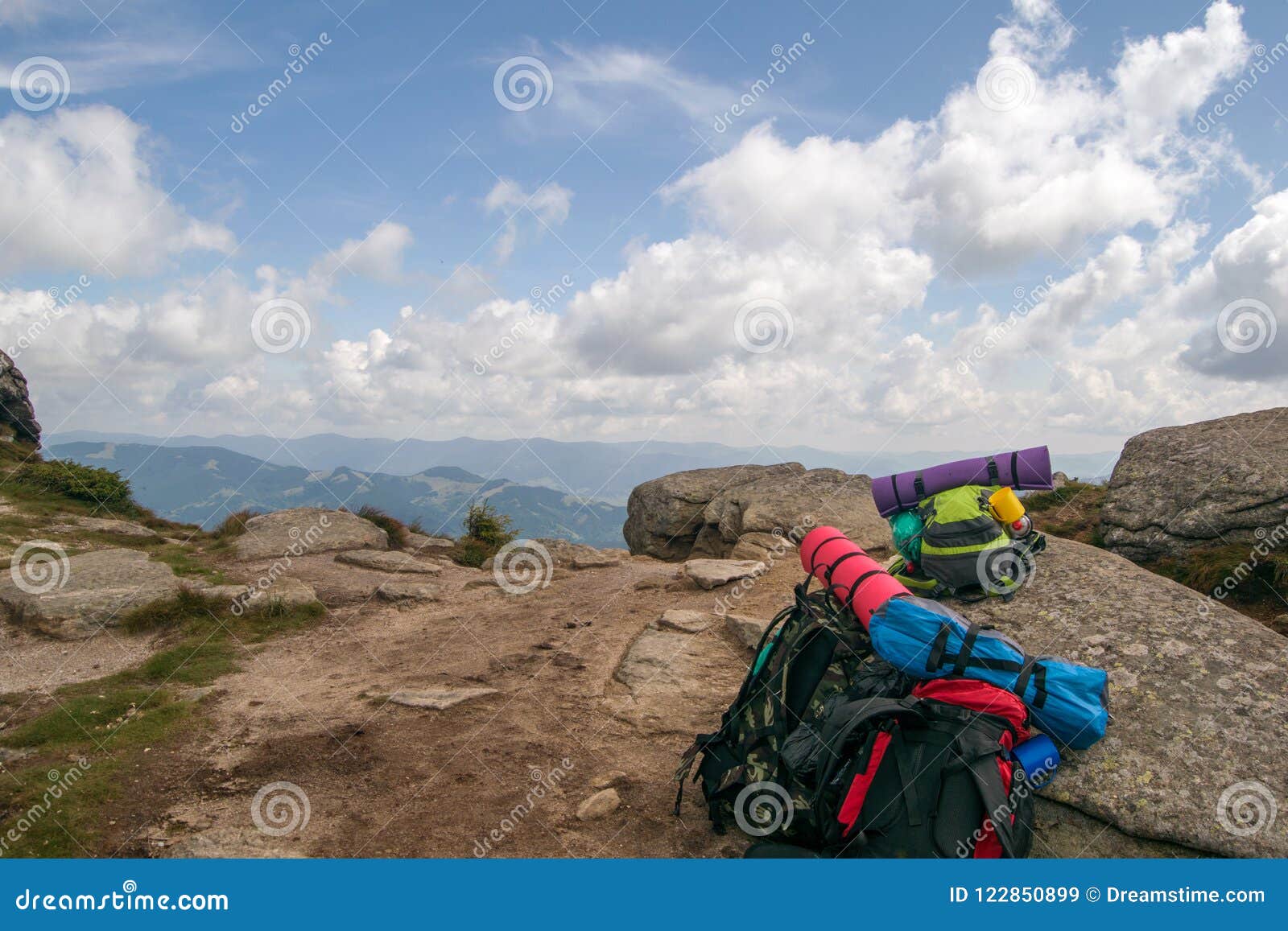 Three Turistic Backpack at the Peak of the Mountain Stock Image - Image ...