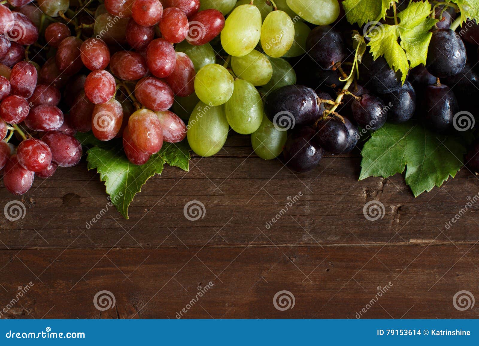 Three Types of Grapes on a Wooden Background Stock Photo - Image of ...