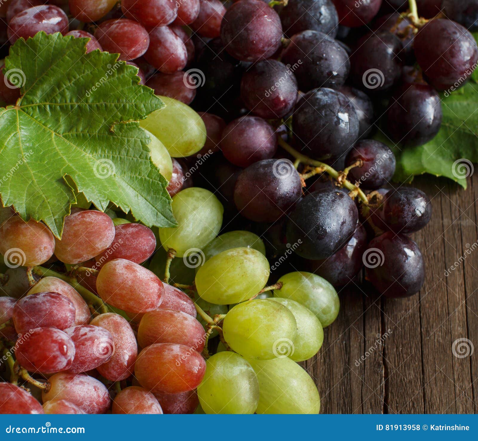 Three Types of Grapes on a Wooden Background Stock Photo - Image of ...