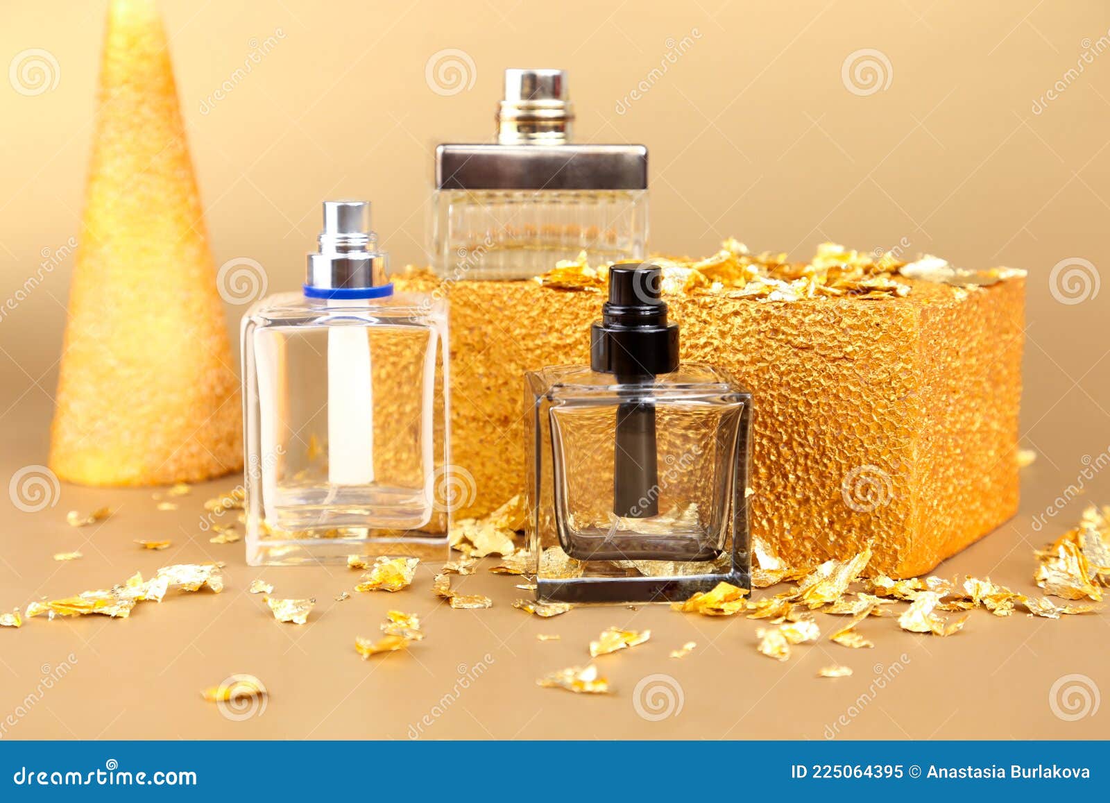 Three Unbranded Perfume Spray Bottles, Pieces of Gold Paper and Golden ...