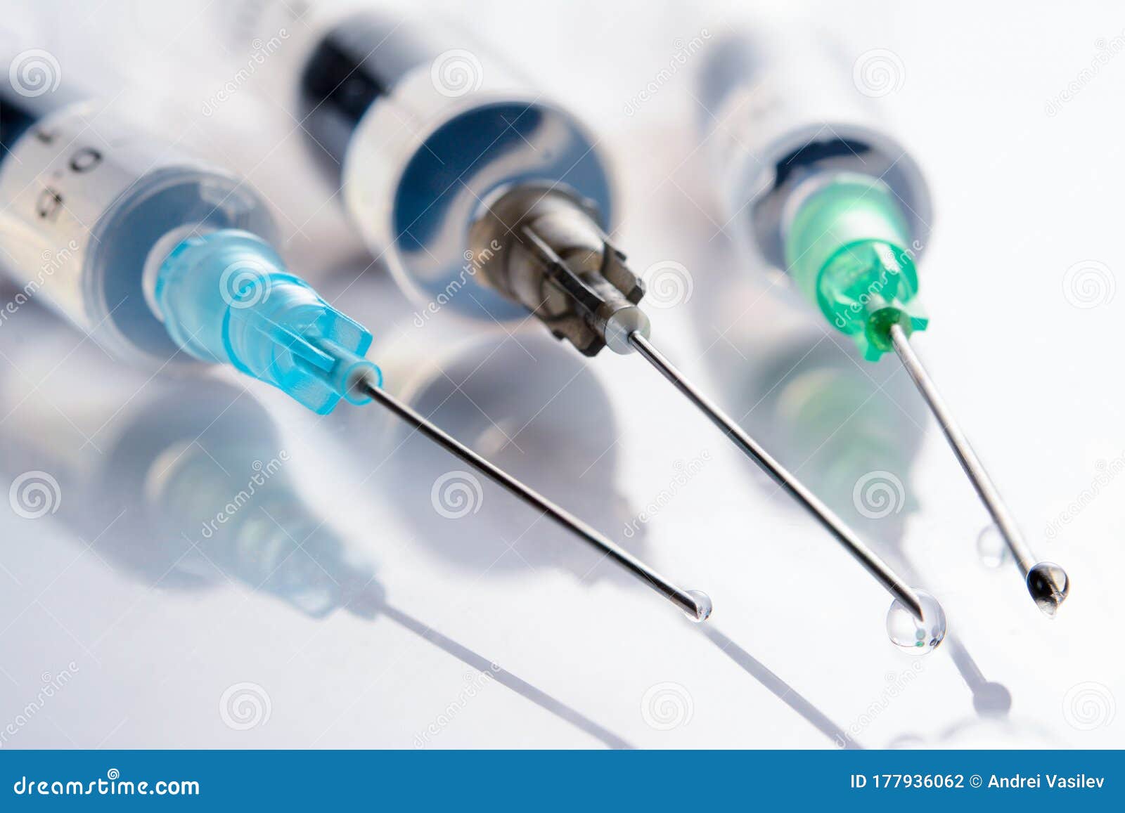 Three Used Syringes with Medicinal Solution, on Light Green Background ...