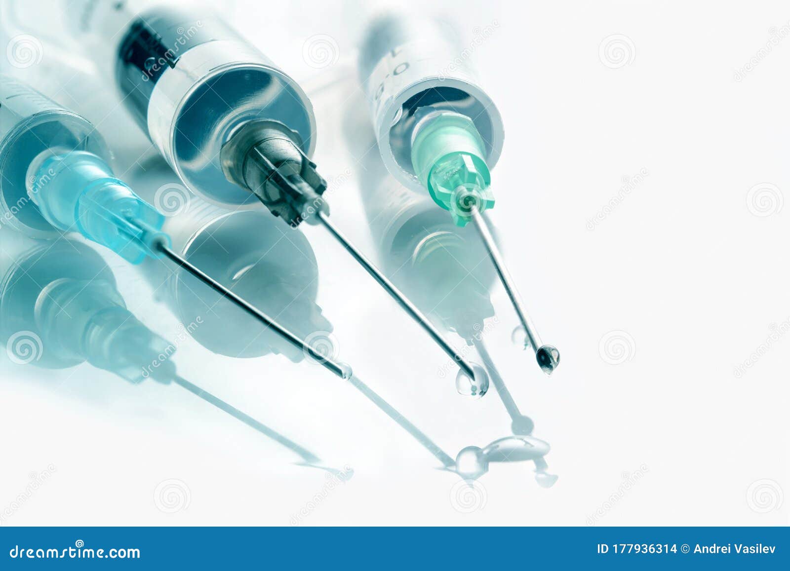 Three Used Syringes with Medicinal Solution, on Light Green Background ...
