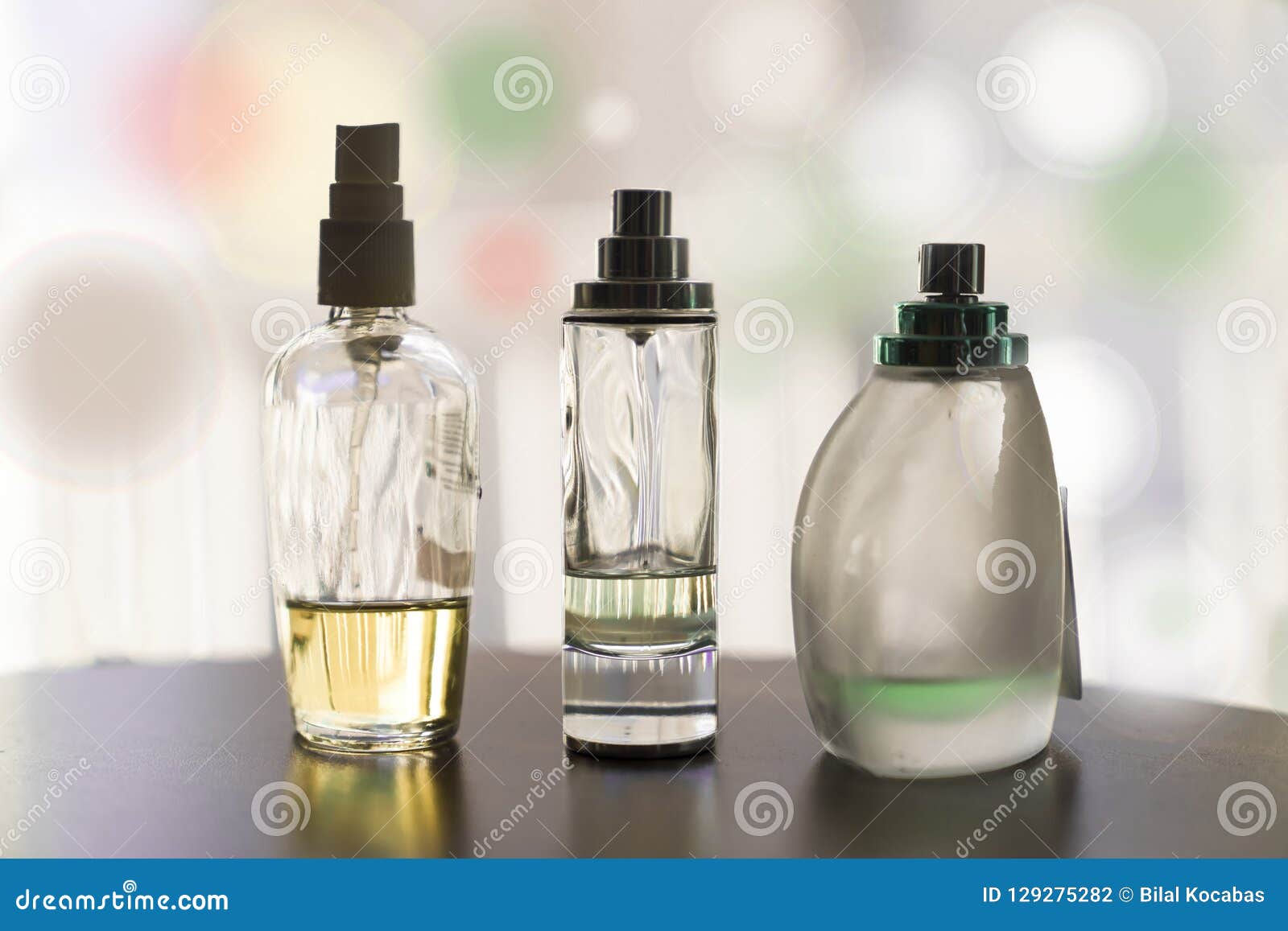 Three Various Half Full Perfume Bottles Stock Photo - Image of cover ...