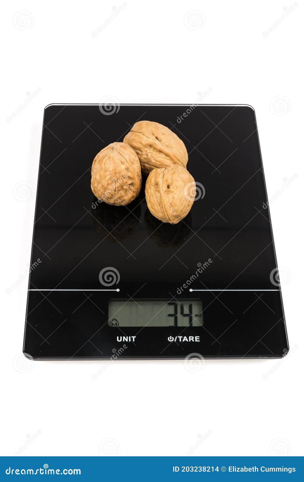 Three Walnuts in the Shell on a Digital Scale Isolated Over White Stock ...