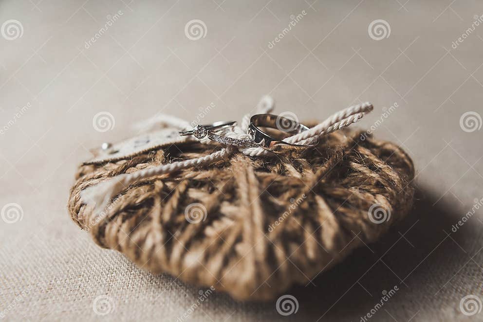 Three Wedding Rings on a Heart Made of Ropes Stock Photo - Image of ...