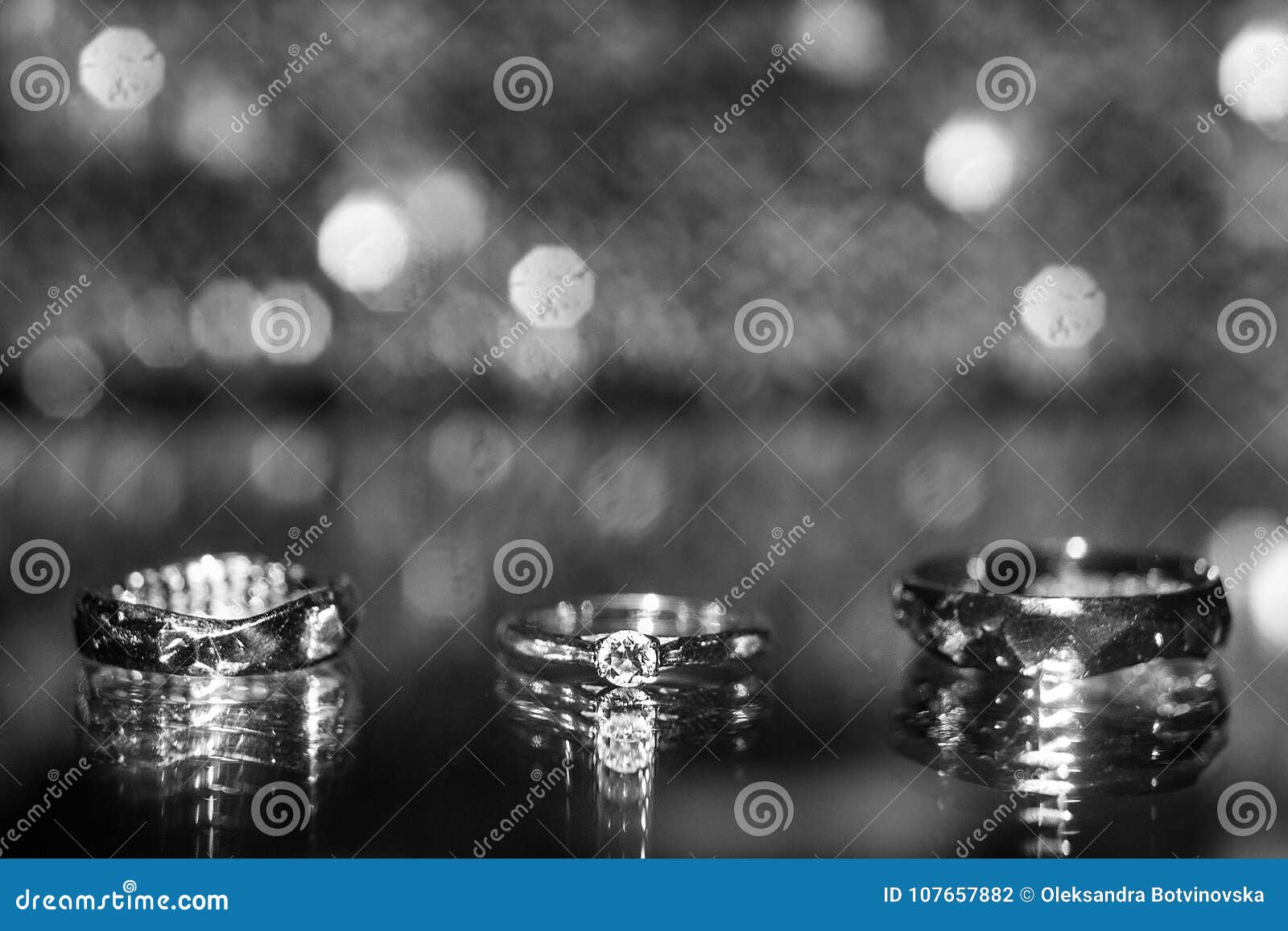 Three Wedding Rings on the Reflecting Surface with Highlights Stock ...