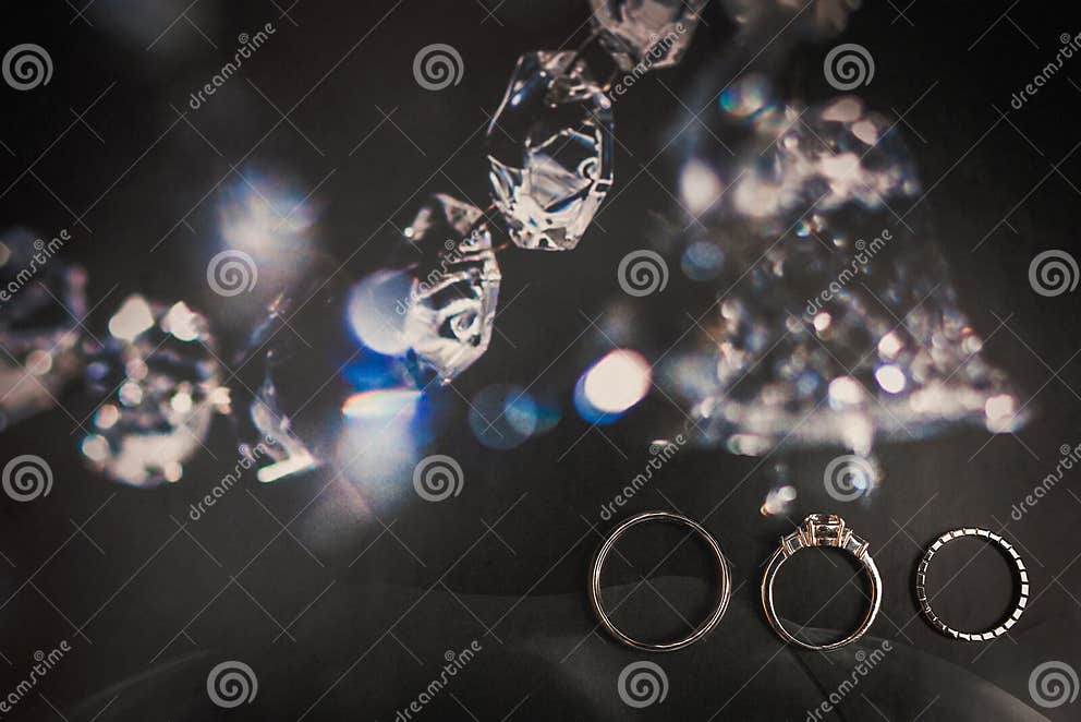 Three Wedding Rings on a Shiny Background Stock Image - Image of ...