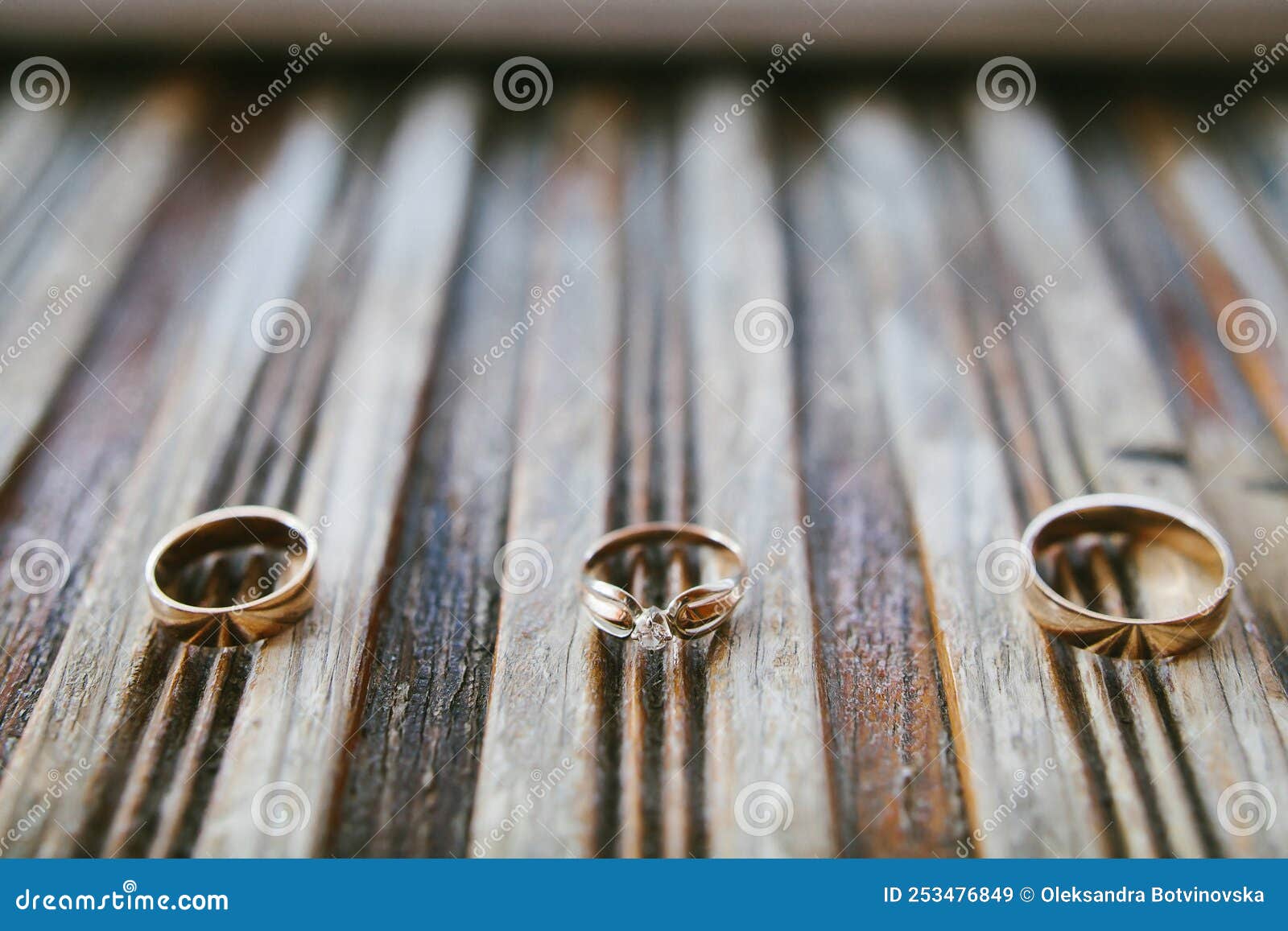 Three Wedding Rings on a Wooden Striped Board Stock Image - Image of ...