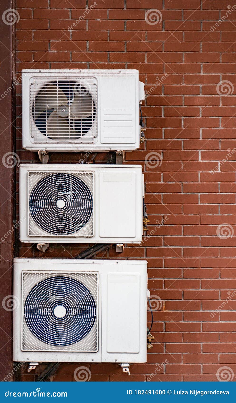 Three White Air Conditioners Attached To a Brick Building Stock Photo ...