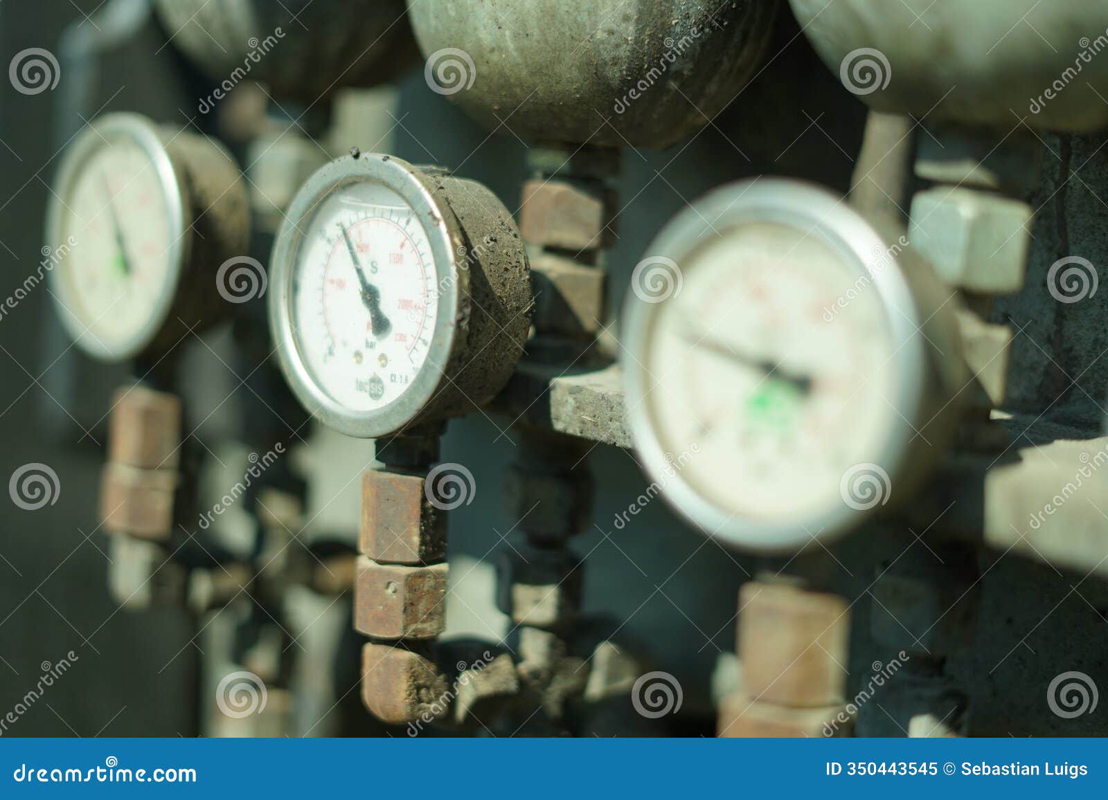 Three White Dials on a Pipe, One of Which is Showing the Time Stock ...